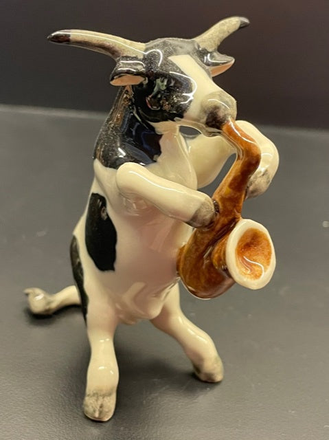 Porcelain Cow Playing the Saxophone. — The Sydney String Centre